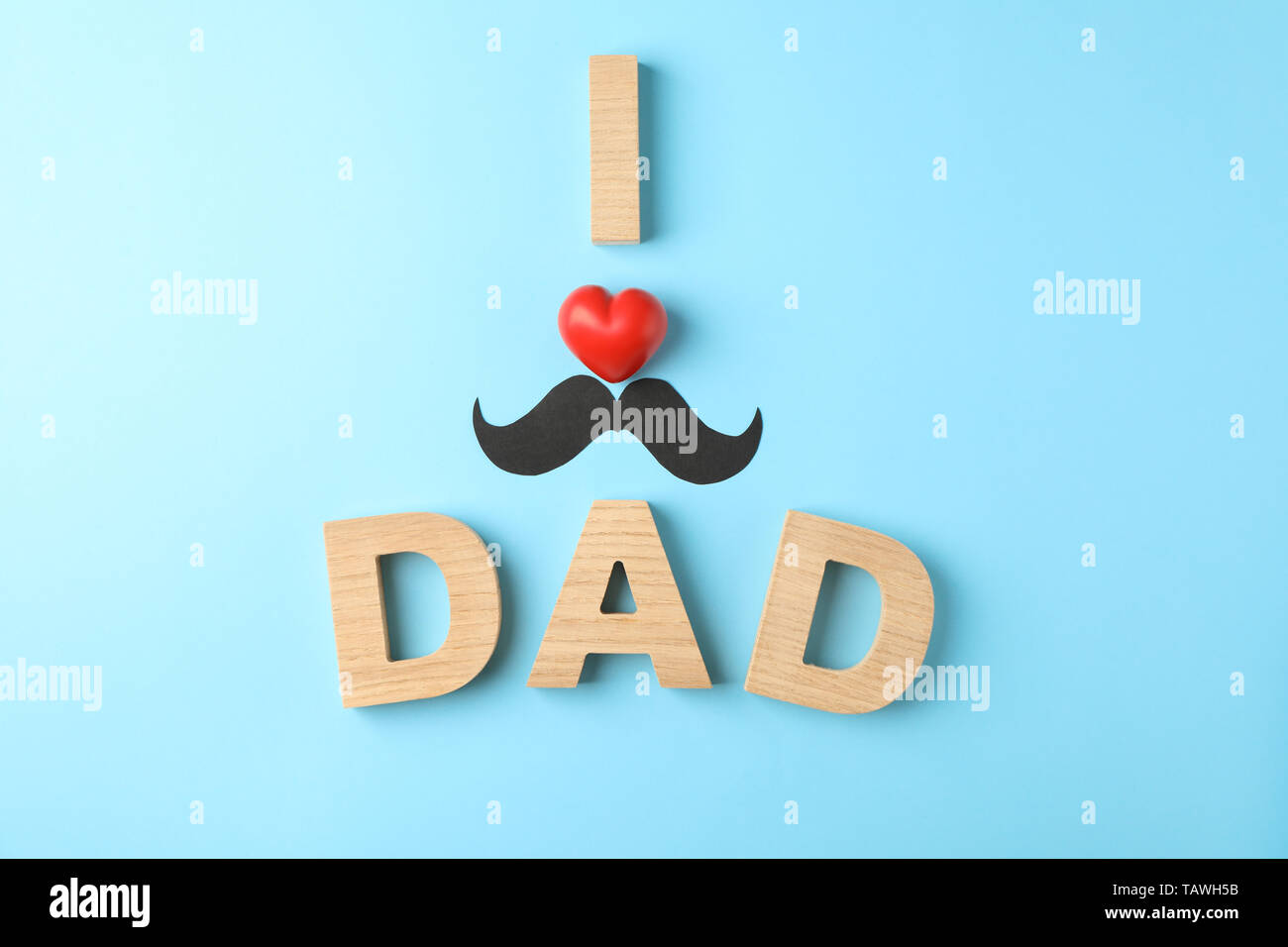 Inscription I love Dad made with wooden letters and red decorative ...