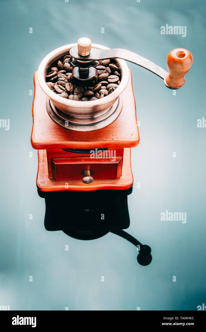 Coffee grinder with coffee beans on the reflective surface. Making ...