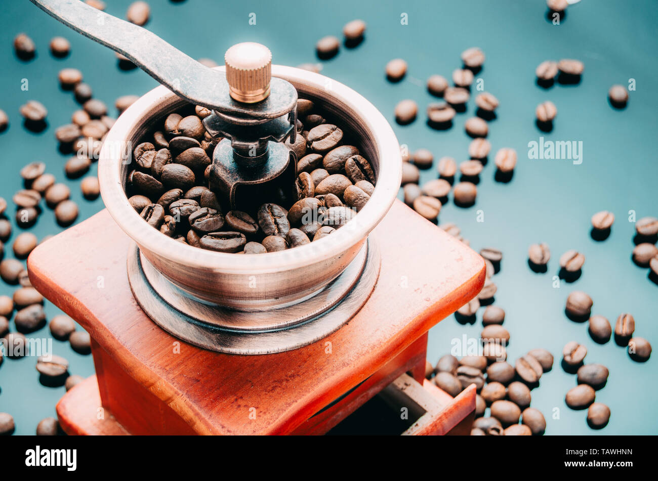 Coffee grinder with coffee beans on the reflective surface. Making ...