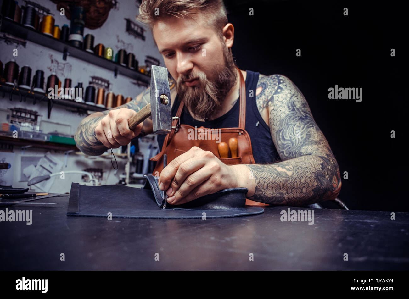 Leather Currier cutting out leather goods Stock Photo - Alamy