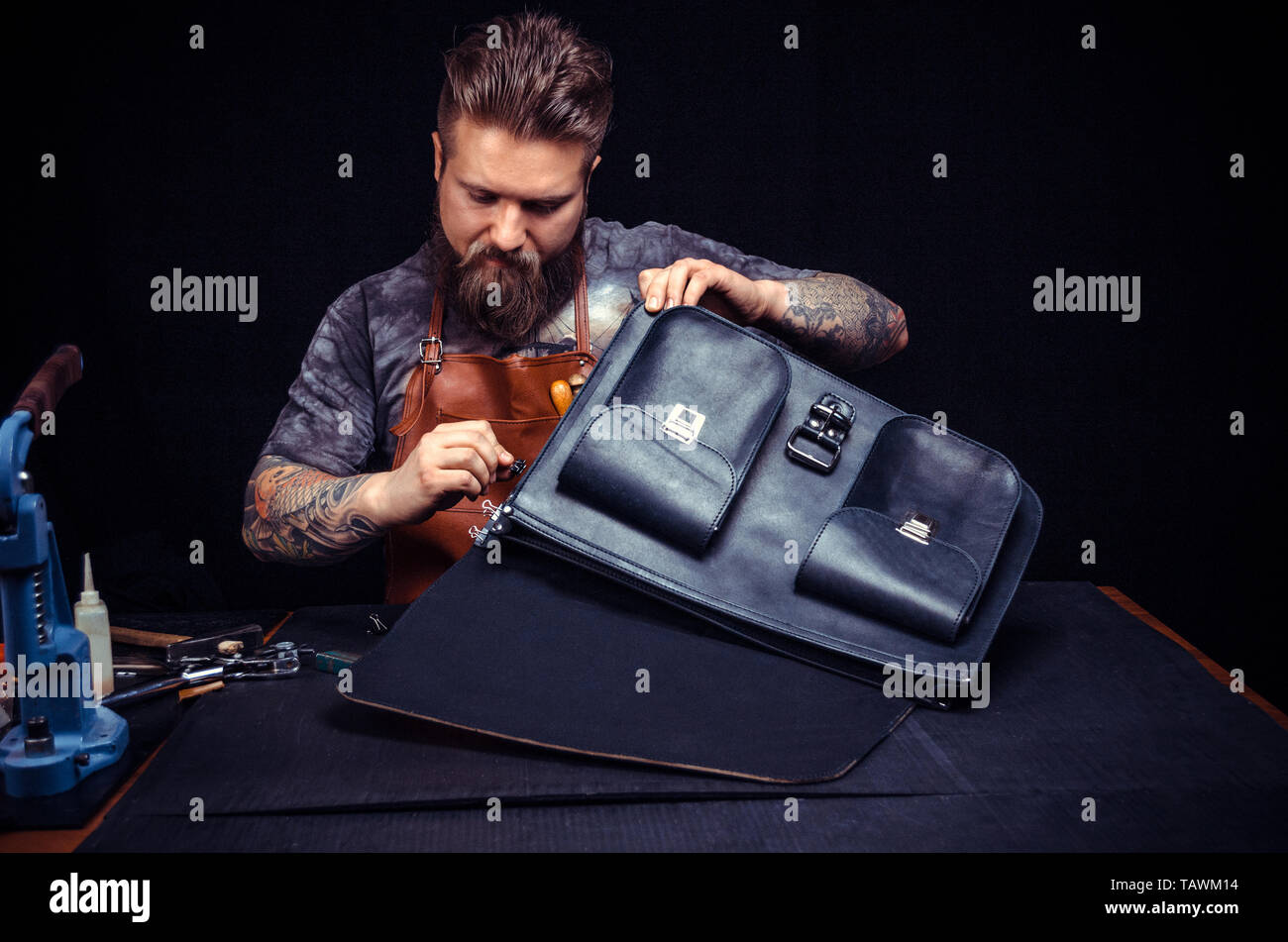Leather Skinner processing a leather workpiece at his workplace Stock ...