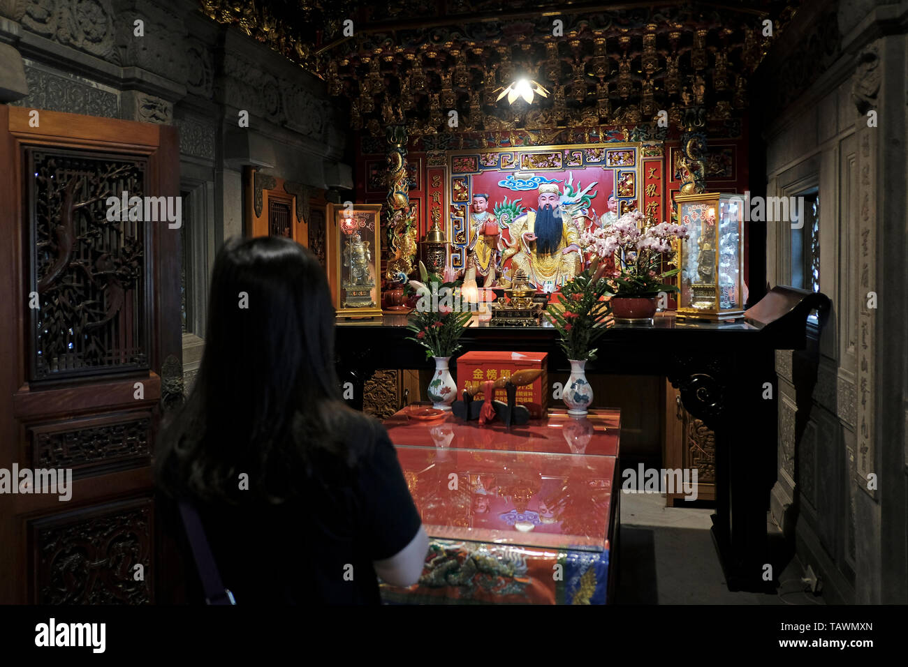 A worshiper pay her respect inside the Taoist Zushi Temple located along Sanxia Old Street in ...