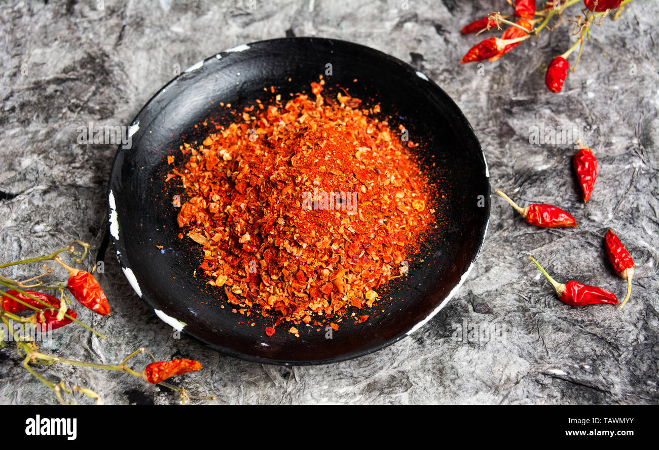 Grounded red pepper in a bowl top view Stock Photo - Alamy