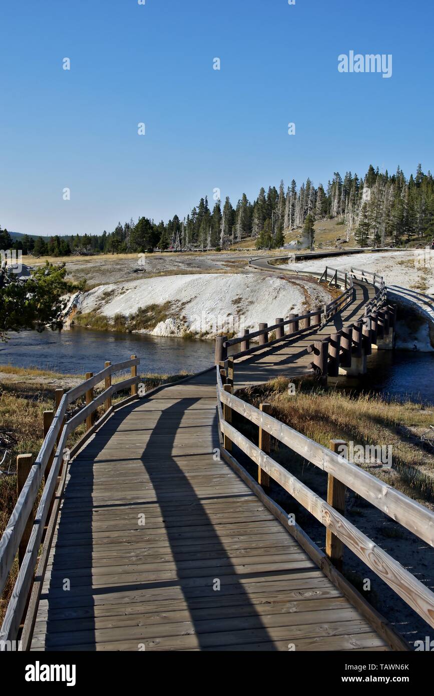 A walkway, bridge with wooden rails across Yellowstone river Stock ...