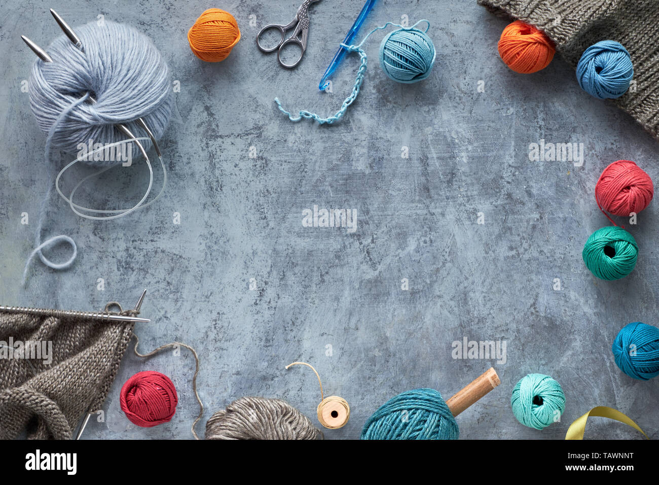 Various wool yarn and knitting needles, dark creative knitting hobby ...