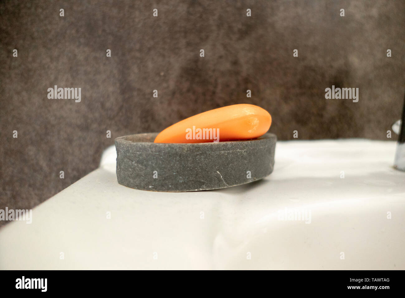orange soap against grey background at the sink in the bathroom Stock ...