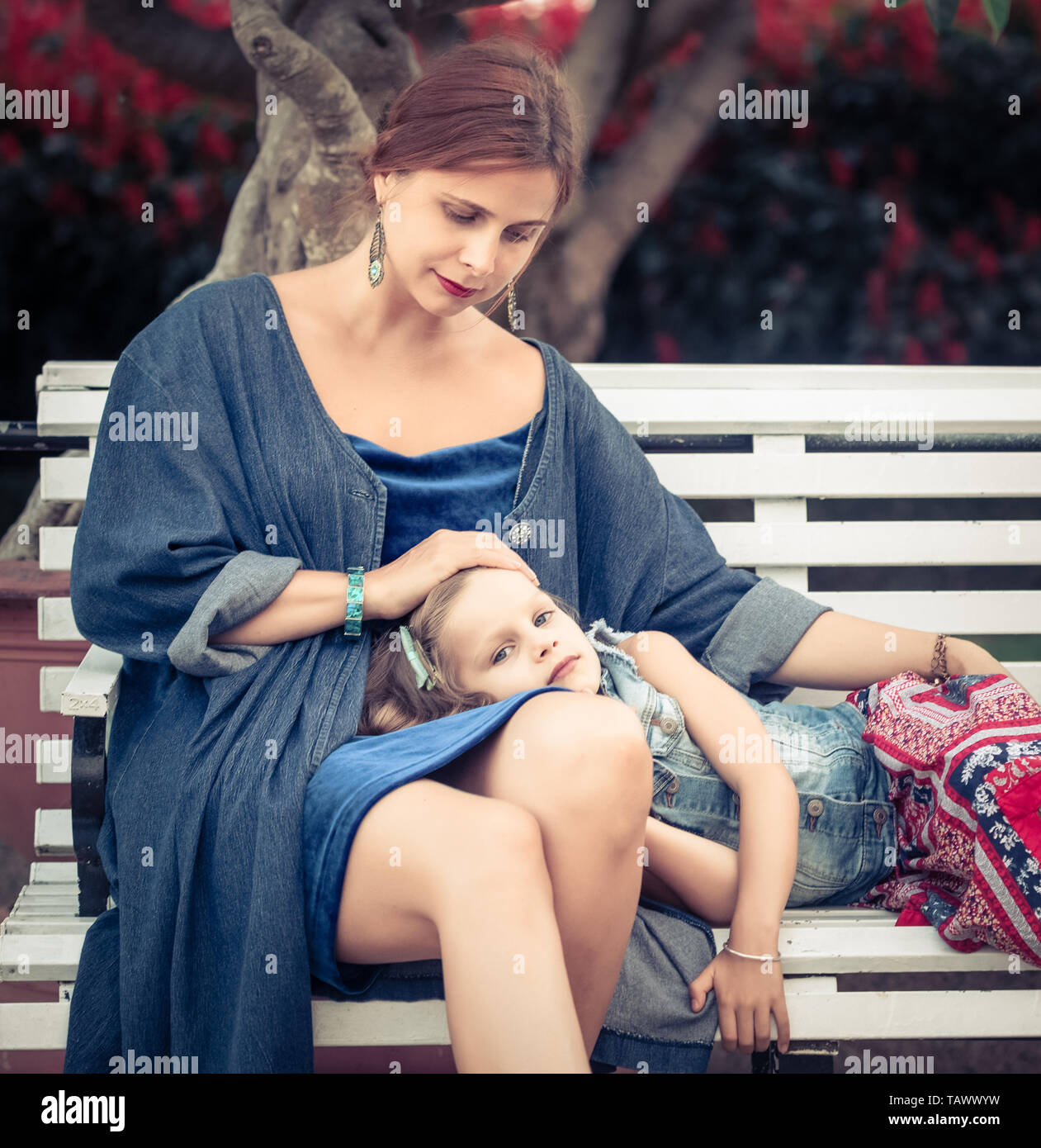 Mother and daughter sitting on a bench in a park Stock Photo - Alamy