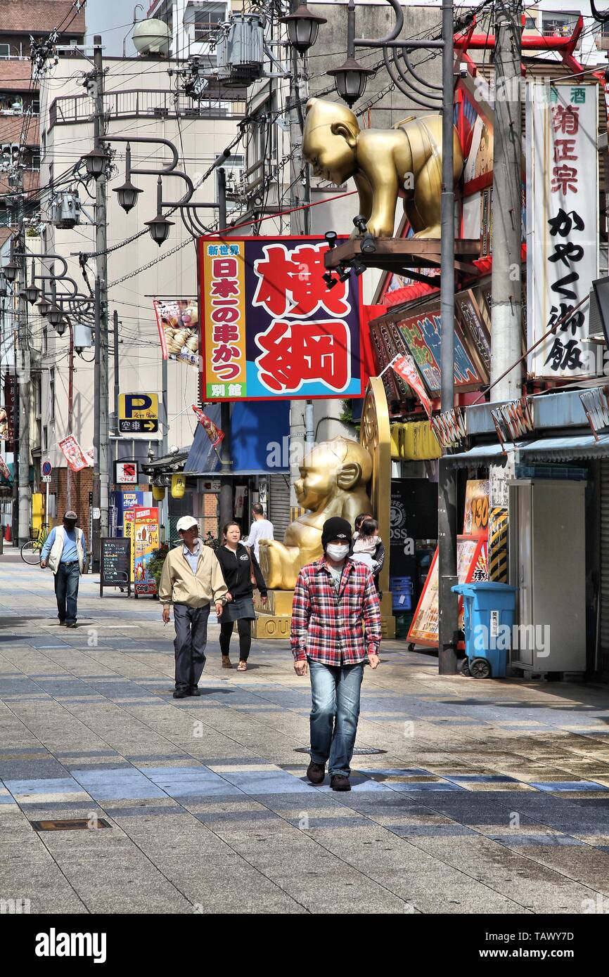 OSAKA, JAPAN - APRIL 25, 2012: People visit Shinsekai district in Osaka ...