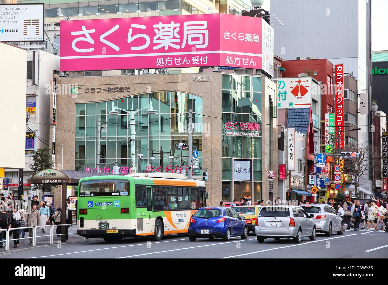 TOKYO, JAPAN - APRIL 12, 2012: People walk in Kanda-Surugadai district ...