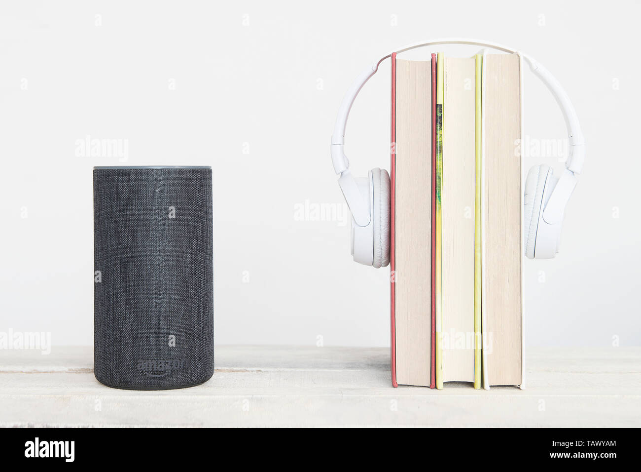 Smart speaker Amazon Alexa Echo device on the left next to some books ...