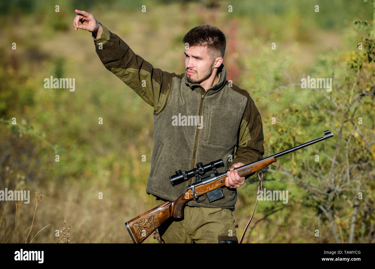 Man brutal unshaved gamekeeper nature background. Hunting permit ...
