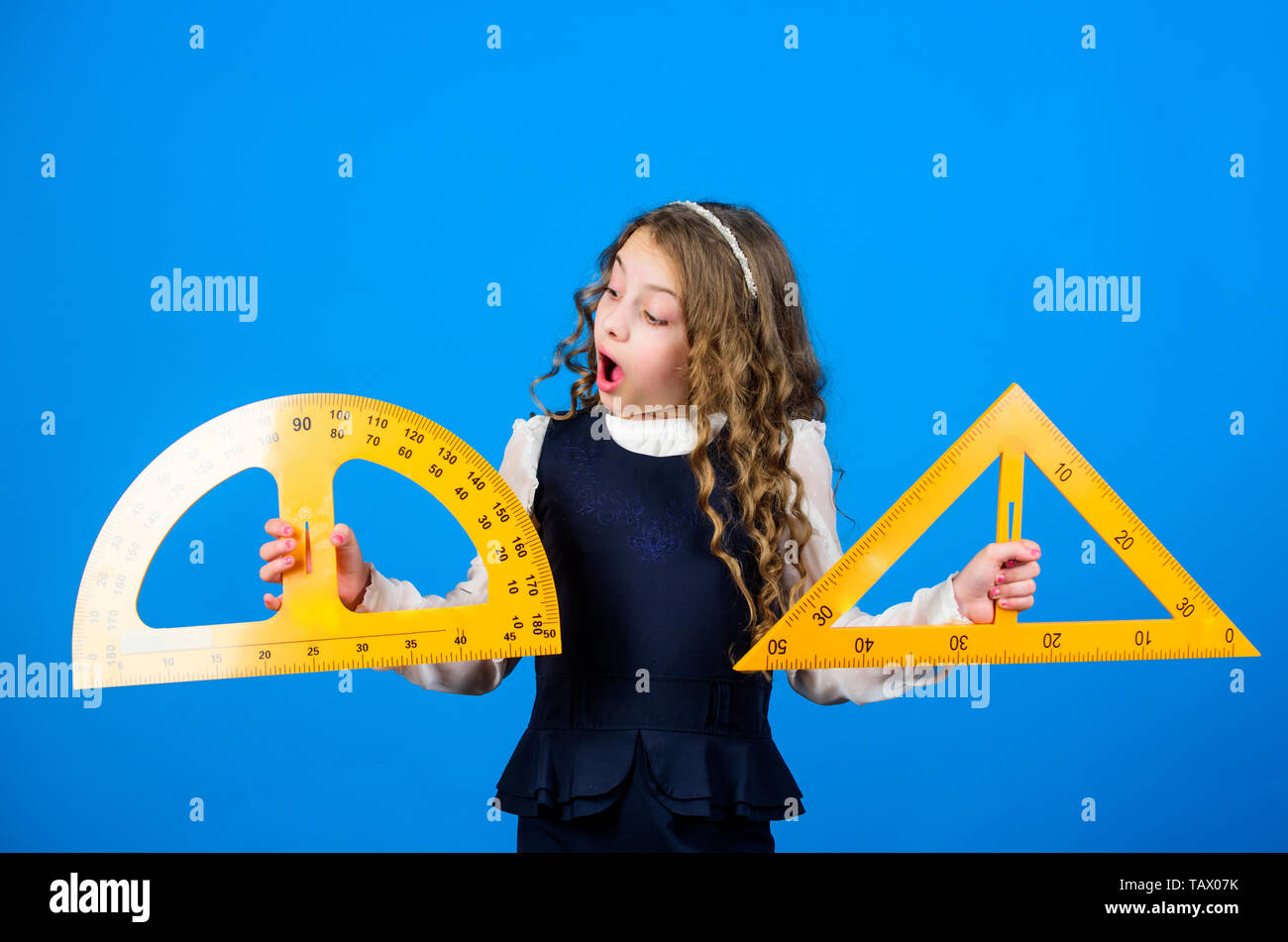 STEM school disciplines. Pupil girl with big rulers. small girl back to ...