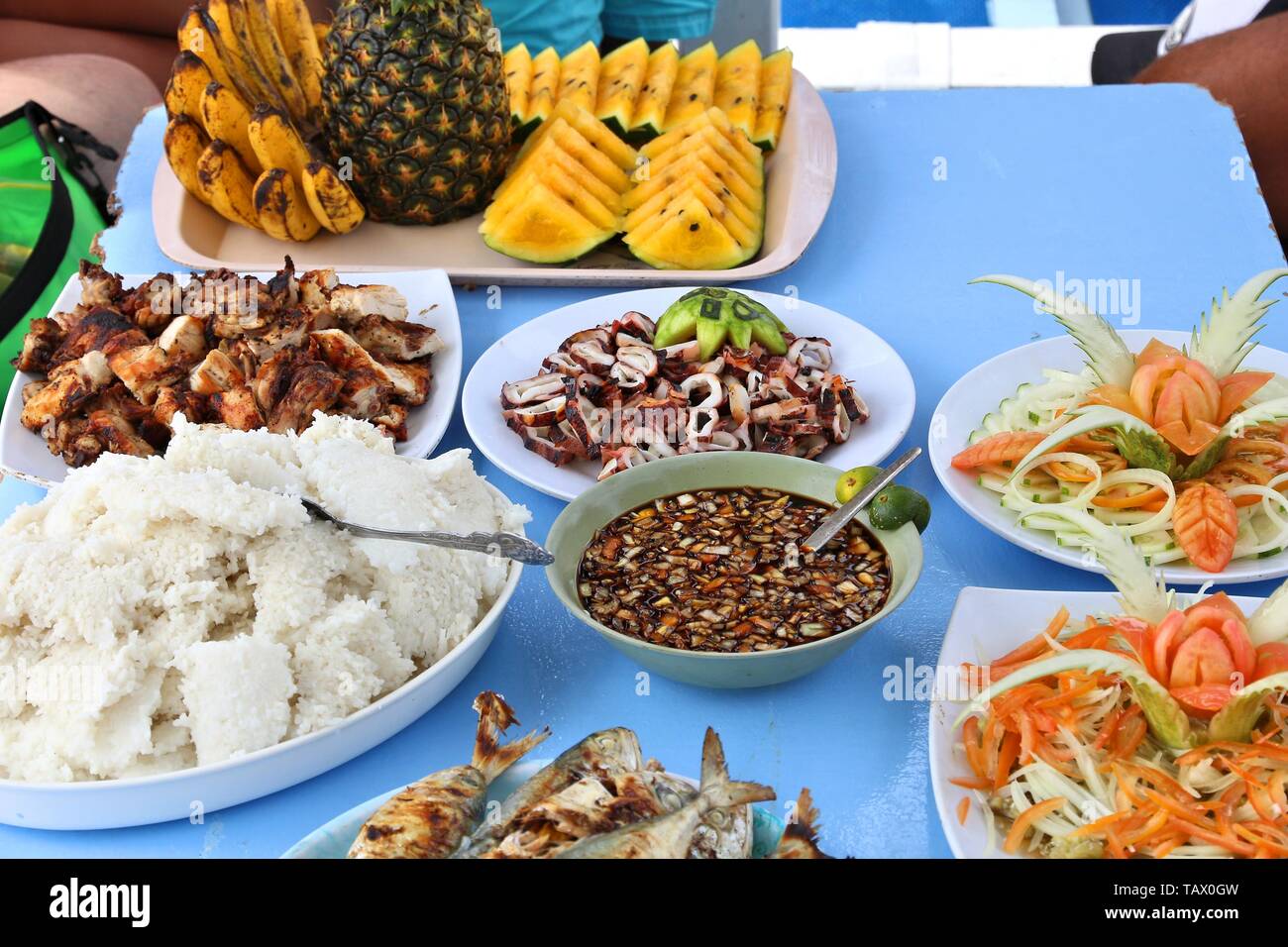 Meat, rice, fruit and seafood lunch in Philippines boat tour Stock ...