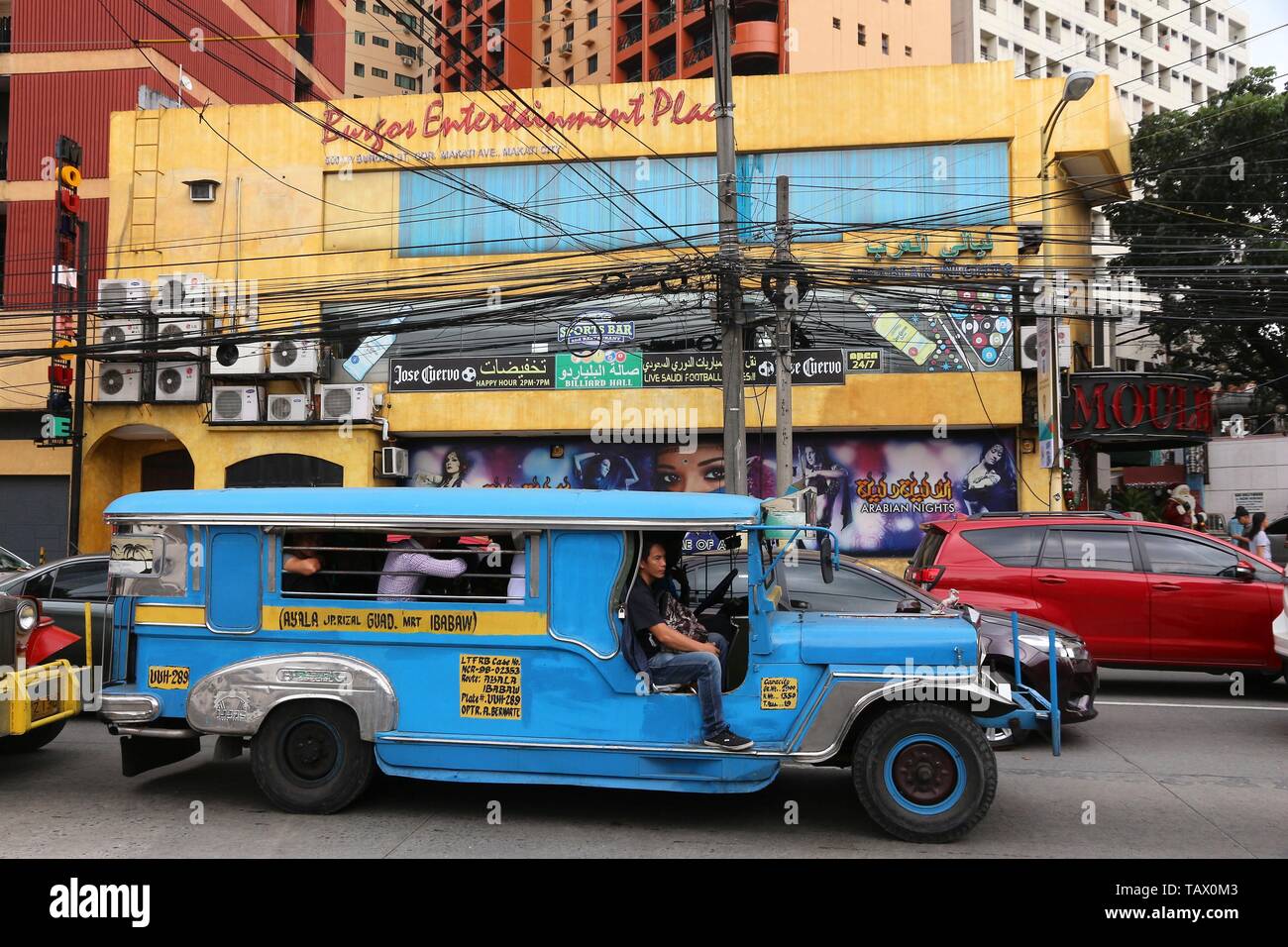 MANILA, PHILIPPINES - DECEMBER 7, 2017: People ride a jeepney public ...