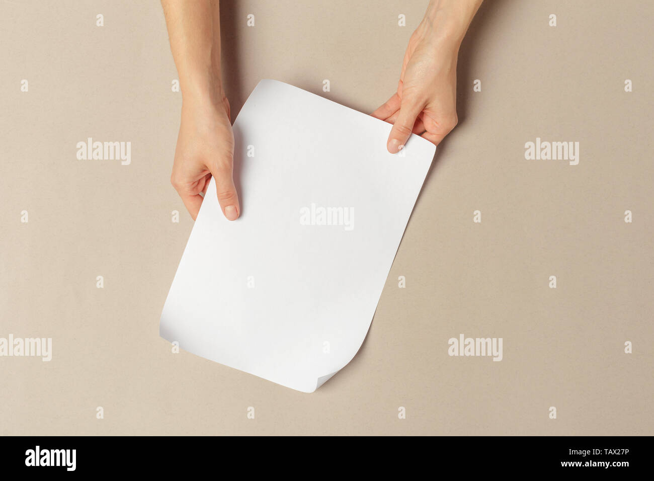 Hand holding papers a4 size Stock Photo - Alamy