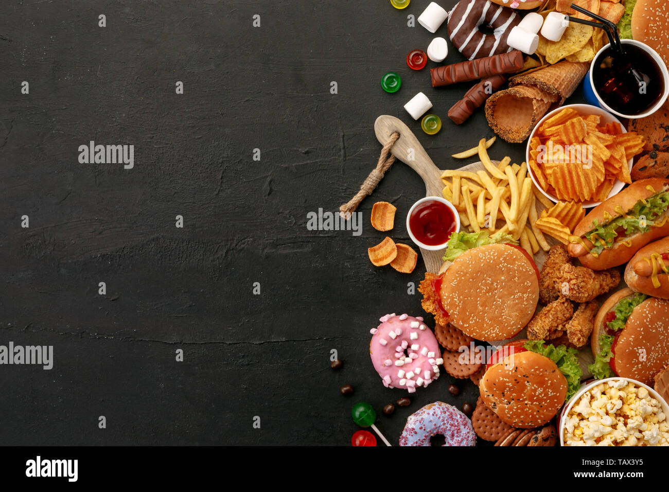 Fast food dish on black stone background. Take away unhealthy set ...
