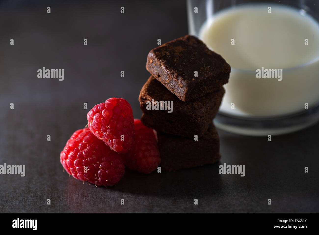 Stack of raspberries and chocolate brownies with a glass of milk Stock ...