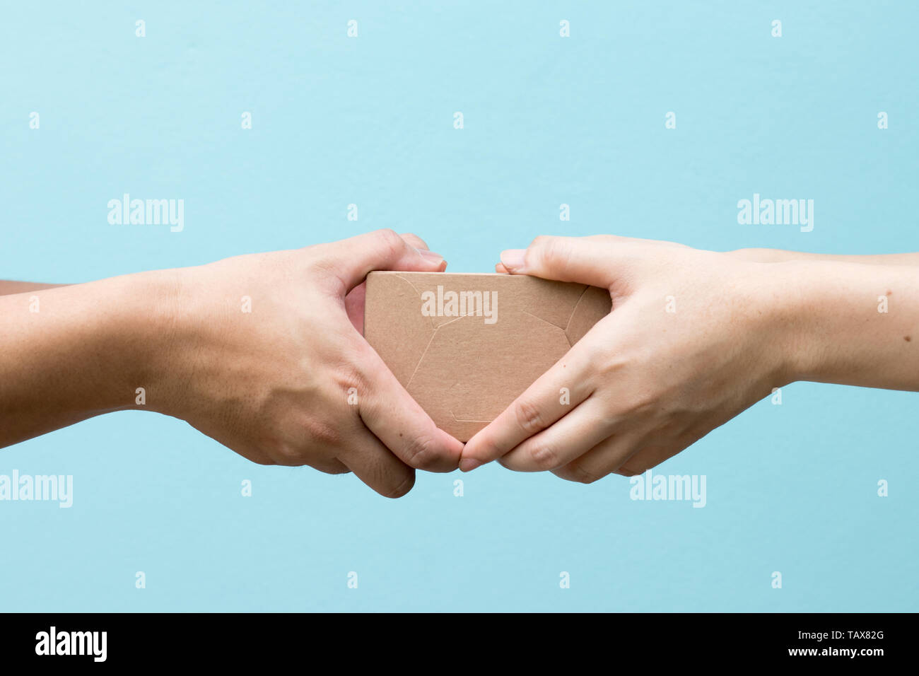 Woman hand received the borwn box delivery from freighter background ...