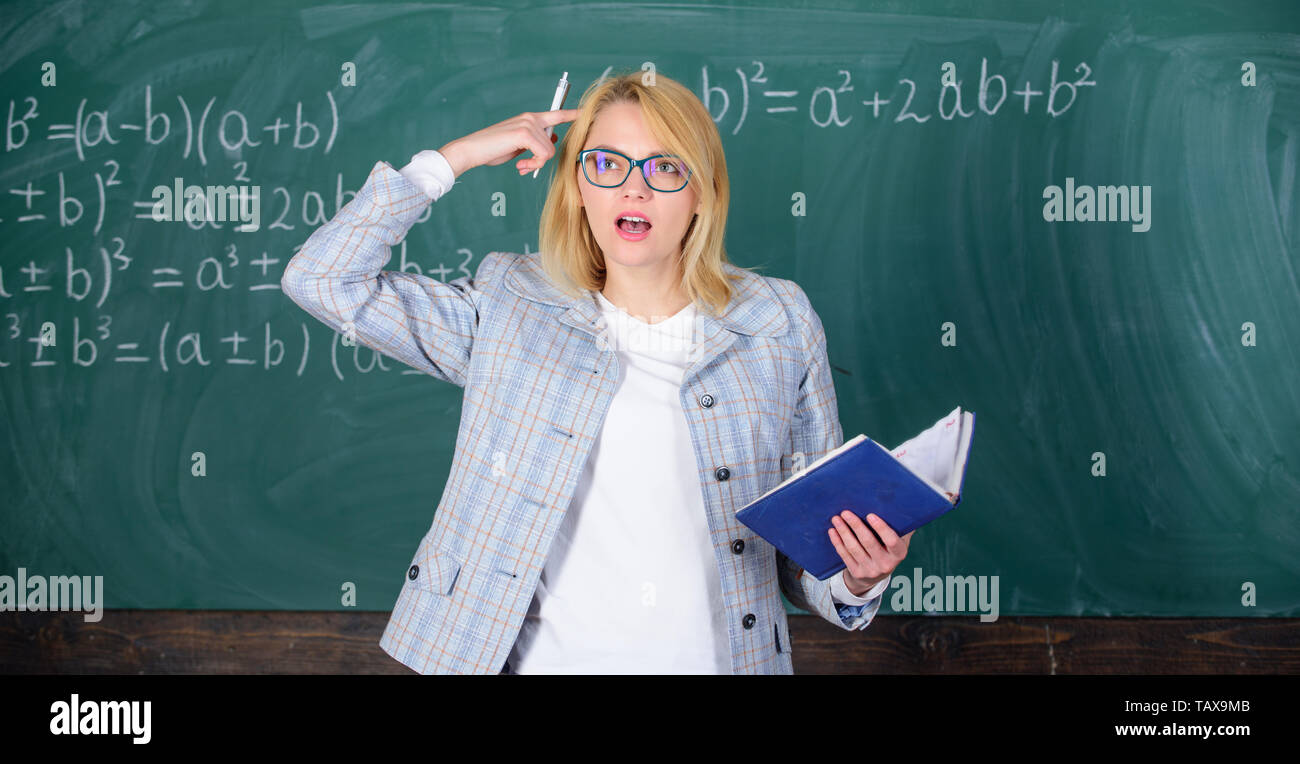 Teacher woman explain near chalkboard. School teacher explain things ...