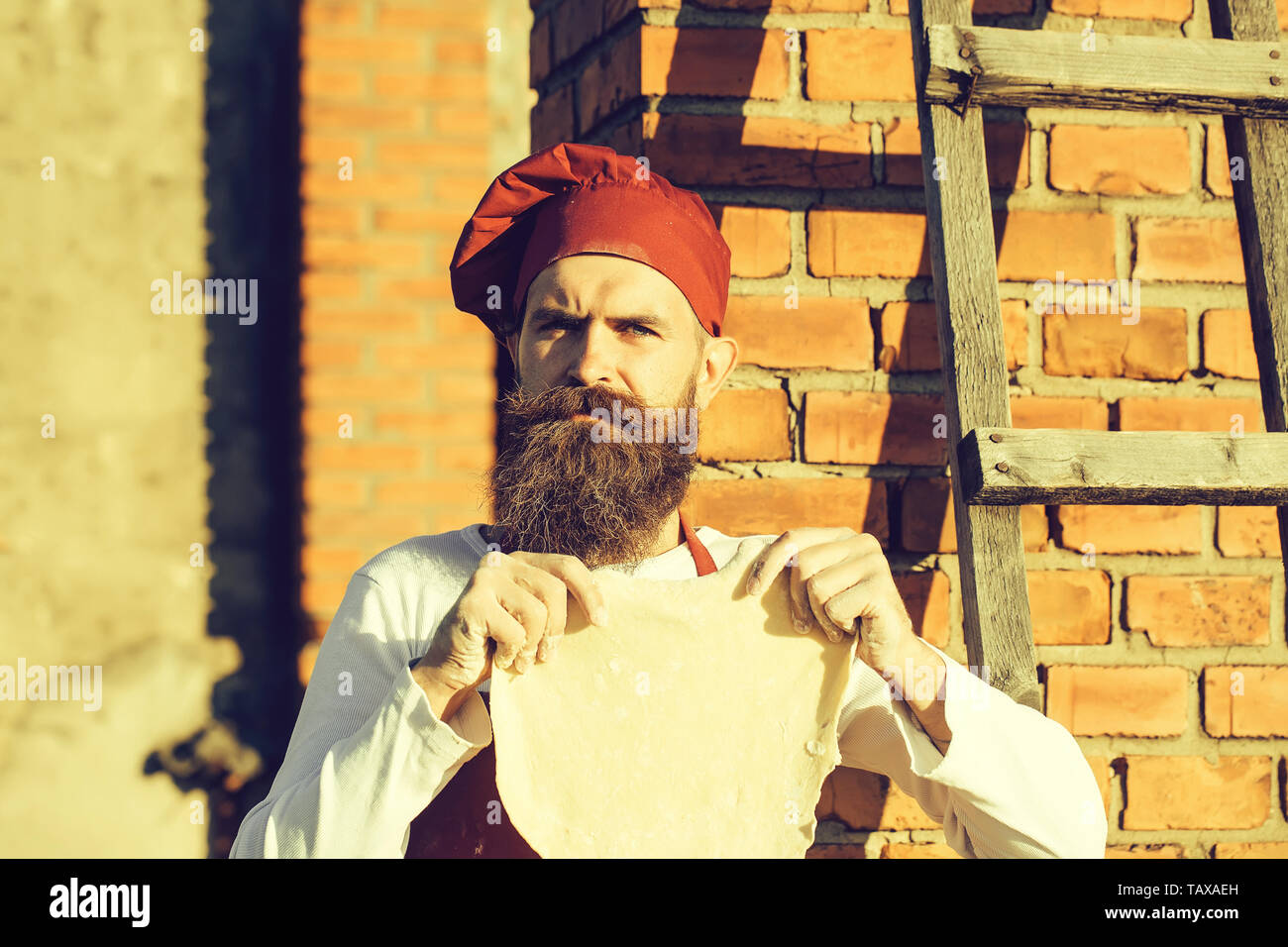 Man cook chef in red hat and apron white uniform with bearded handsome ...
