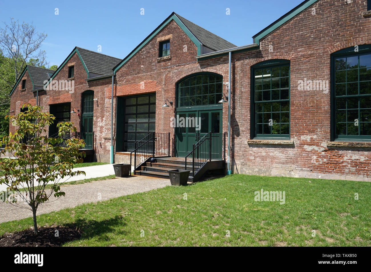 Exterior of an old silk mill. The facade has red brick, industrial ...