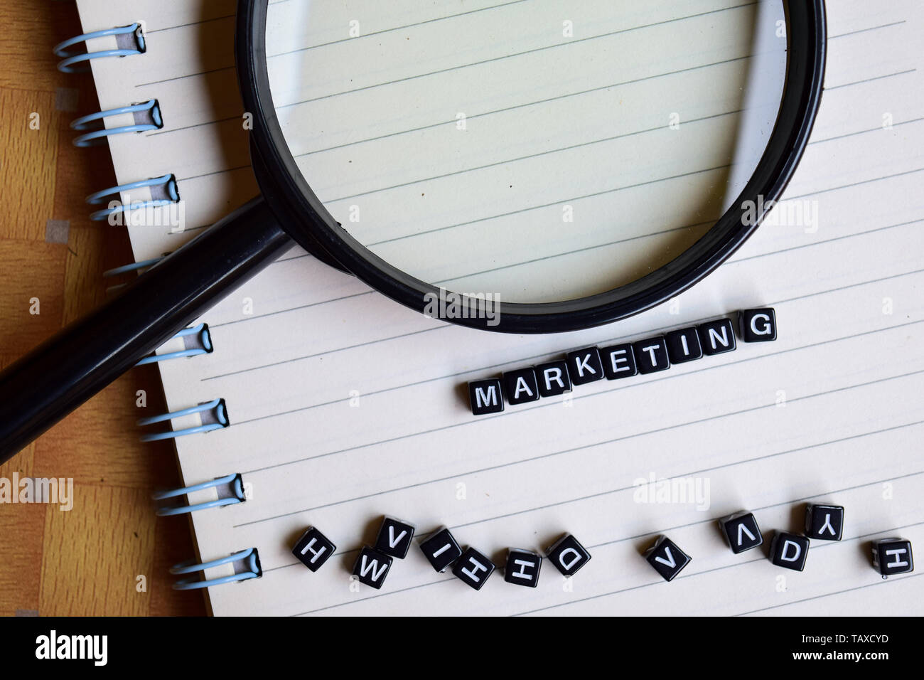 Marketing on wooden block and magnifying glass. Motivation concept ...