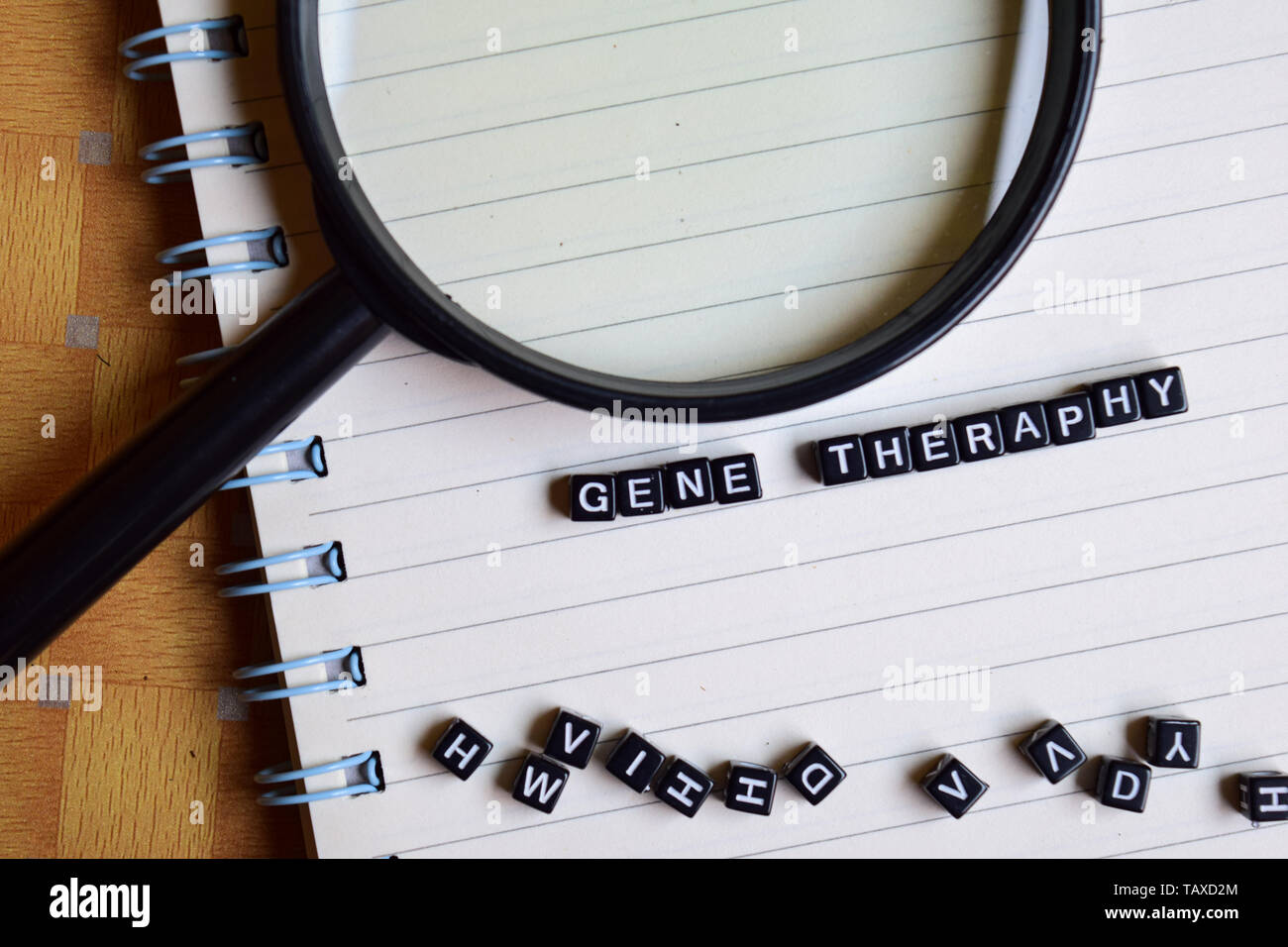 Gene Theraphy on wooden block and magnifying glass. Motivation concept ...