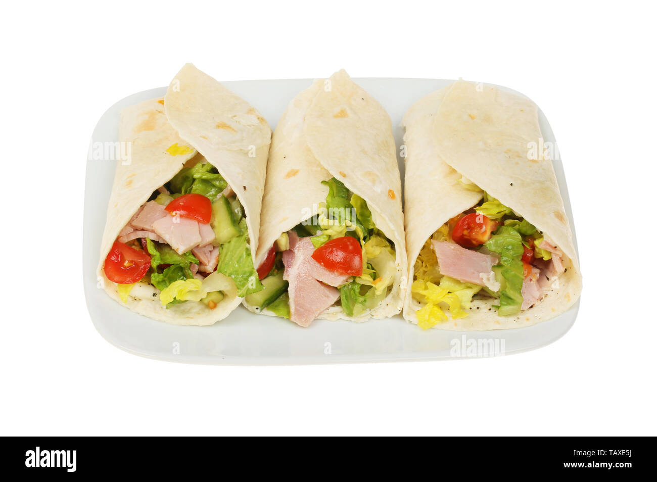 Ham salad wraps on a plate isolated against white Stock Photo - Alamy