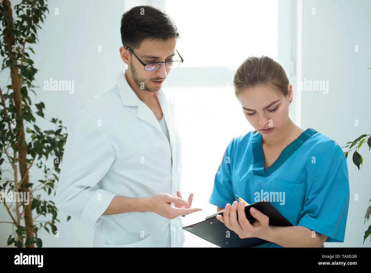 Healthcare workers looking into medical documents in the hospital Stock ...