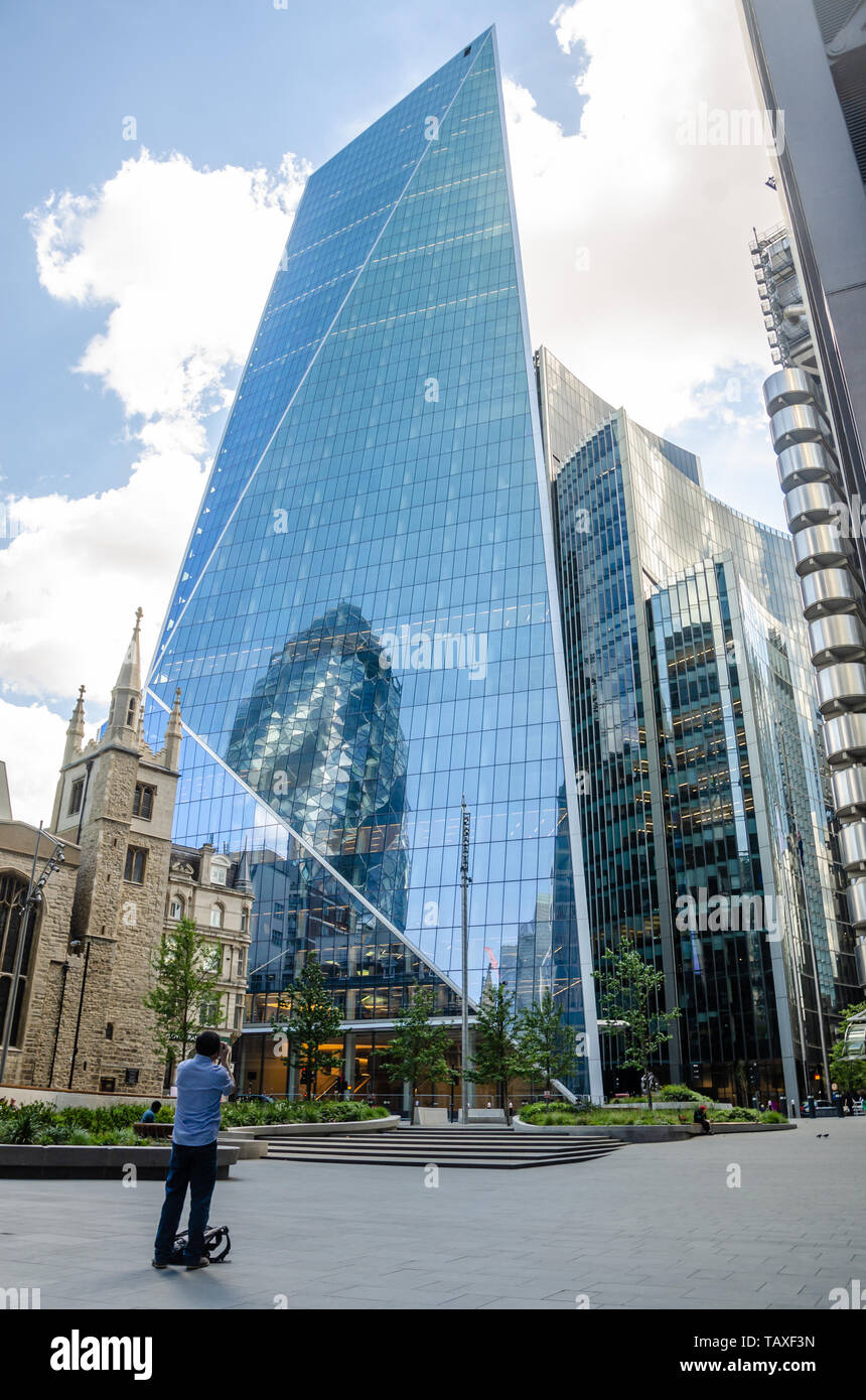 The Gherkin reflects in the side of The Scalpel on a sunny day in the ...