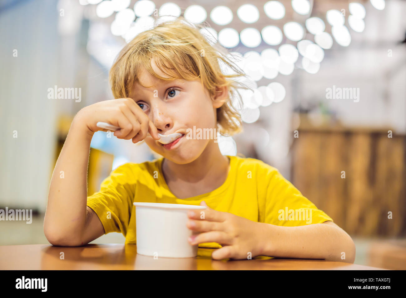 Boy eating ice cream in a cafe Stock Photo - Alamy