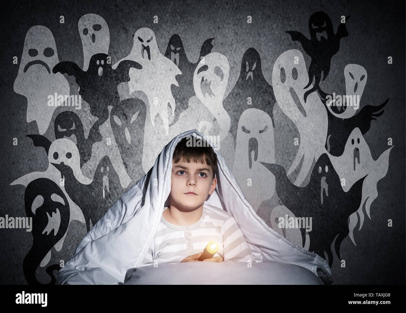 Little child with flashlight hiding under blanket Stock Photo - Alamy
