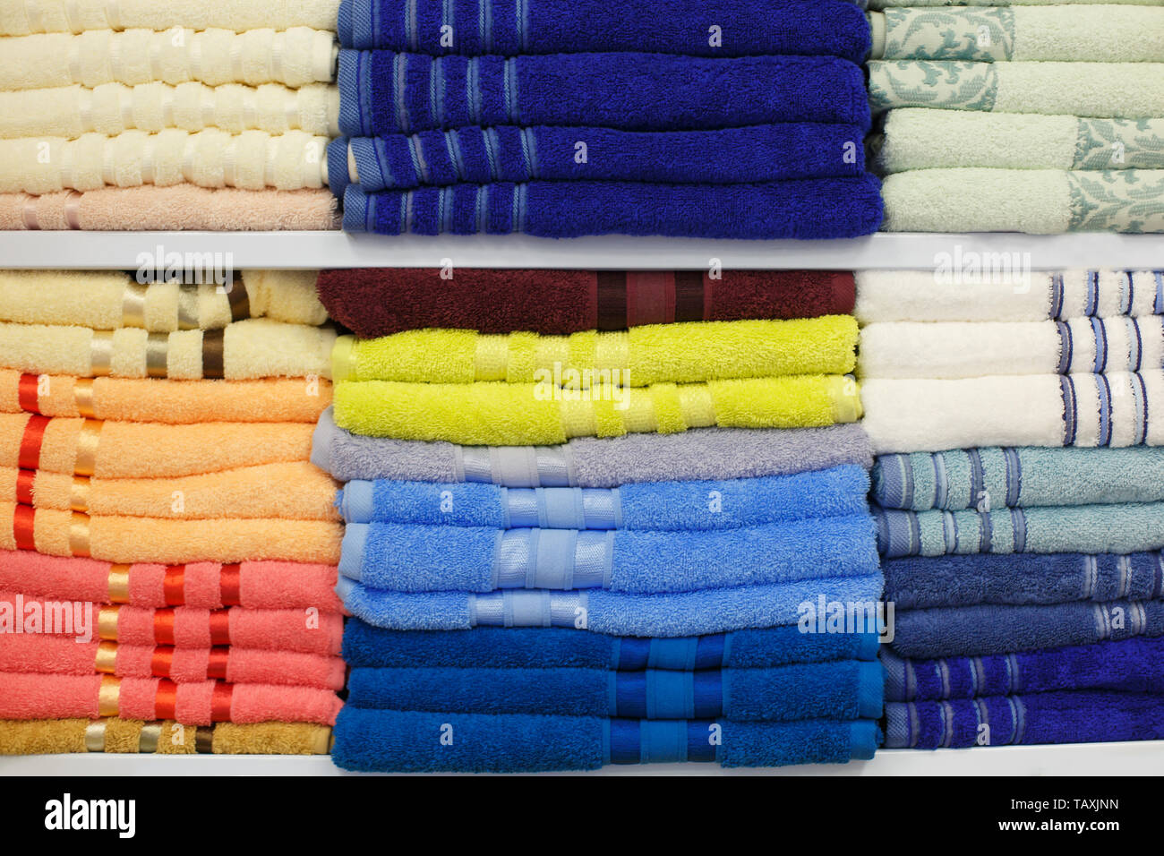 Fresh Hotel Towels Folded and Stacked on a Shelf. Colorful cotton ...