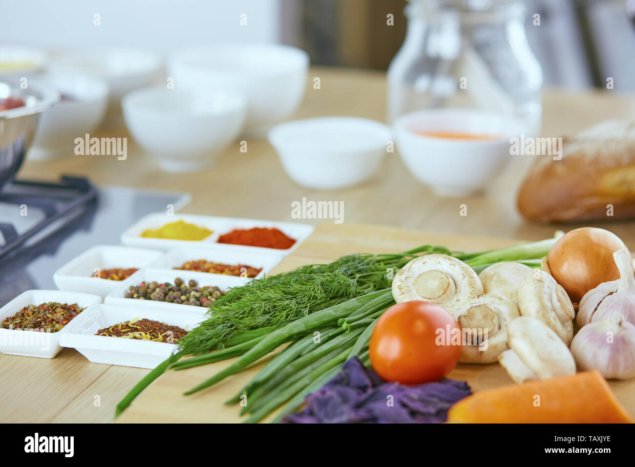 Composition with wooden board and ingredients for cooking on table ...