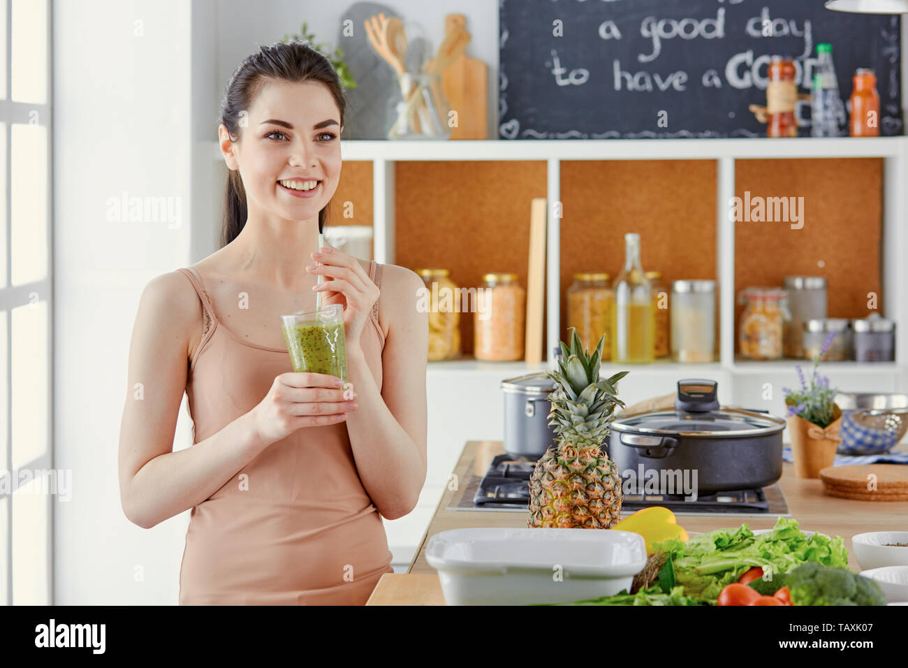 a young girl drinks a cocktail on a kitchen Stock Photo - Alamy