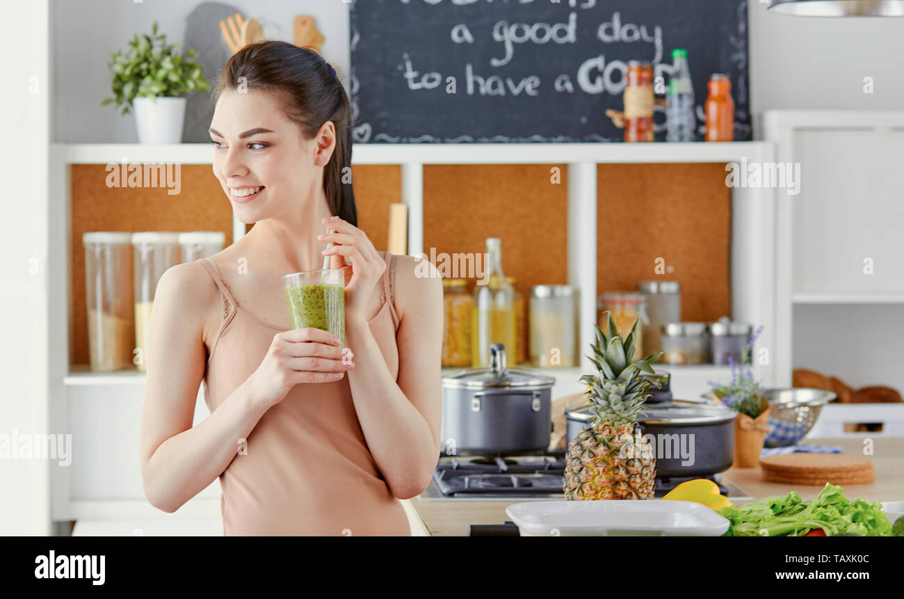 a young girl drinks a cocktail on a kitchen Stock Photo - Alamy