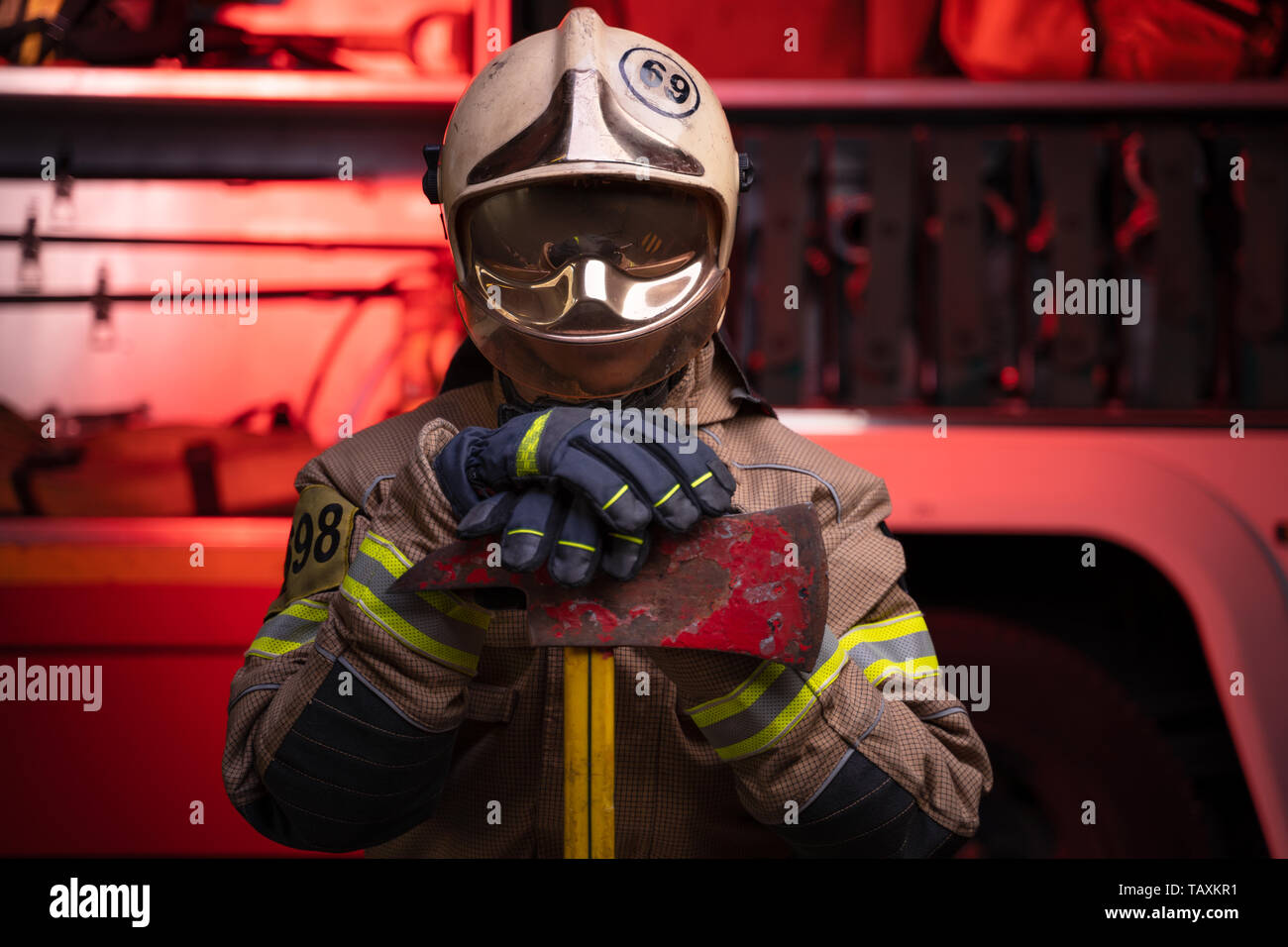Image of man fireman in helmet and mask on background of fire truck ...