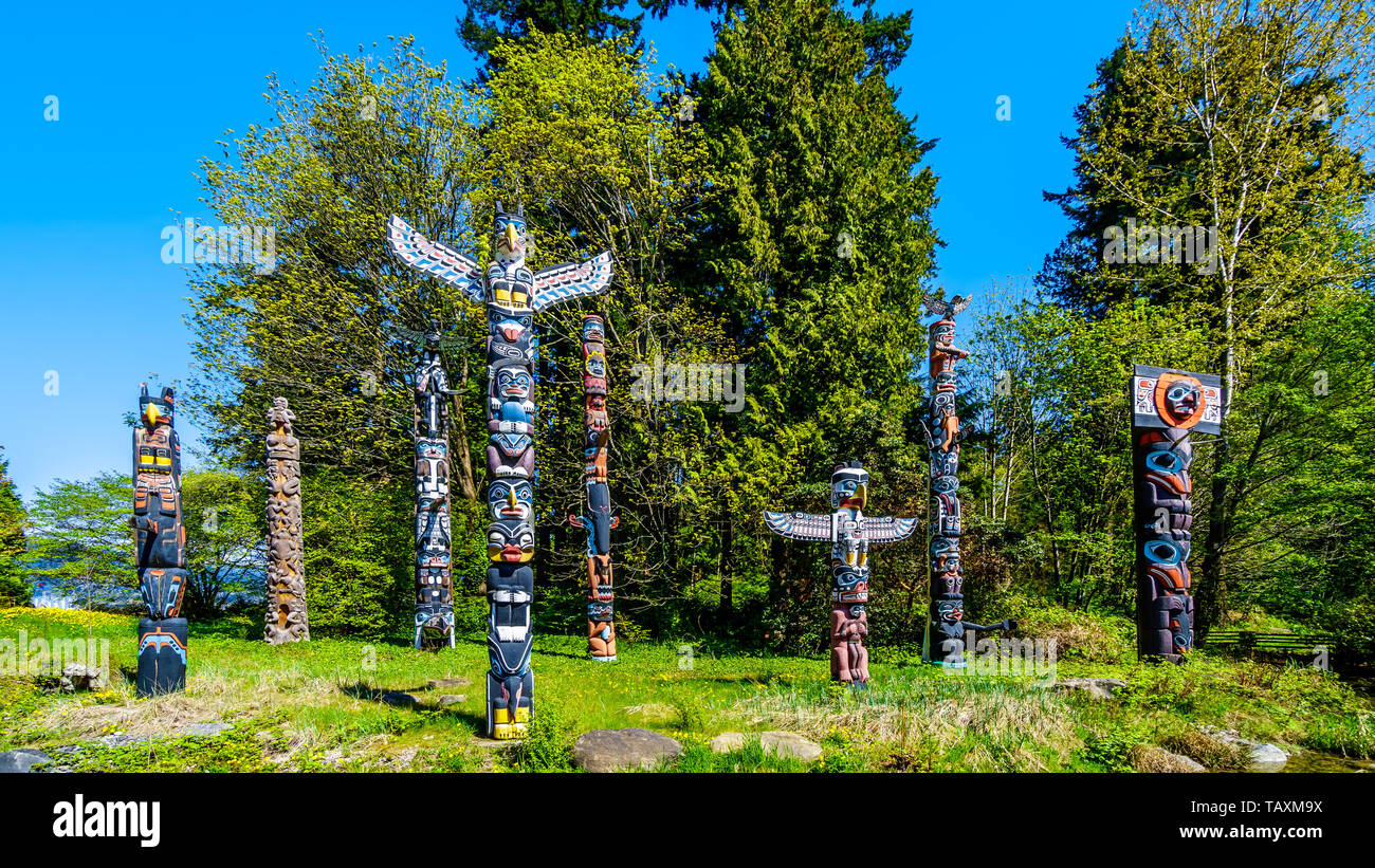 Colorful indigenous Totem Poles representing art and religious symbols ...