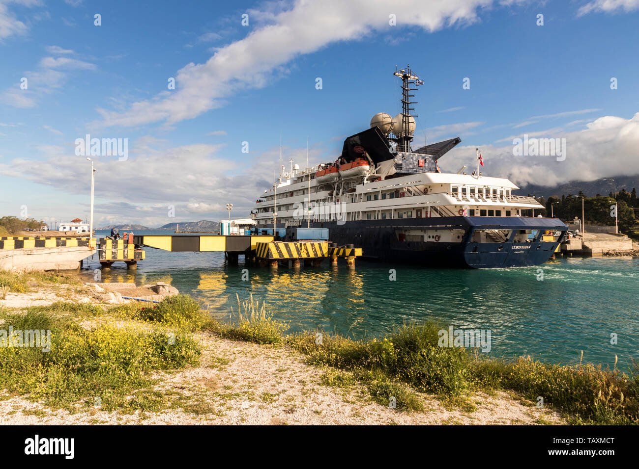 Corinth, Greece. Large ship with tugboat crossing the Corinth Canal, a ...