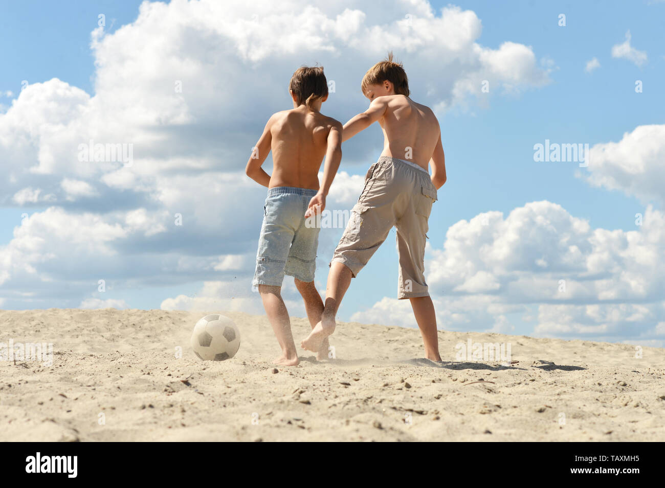 Boys brothers playing football soccer hi-res stock photography and ...