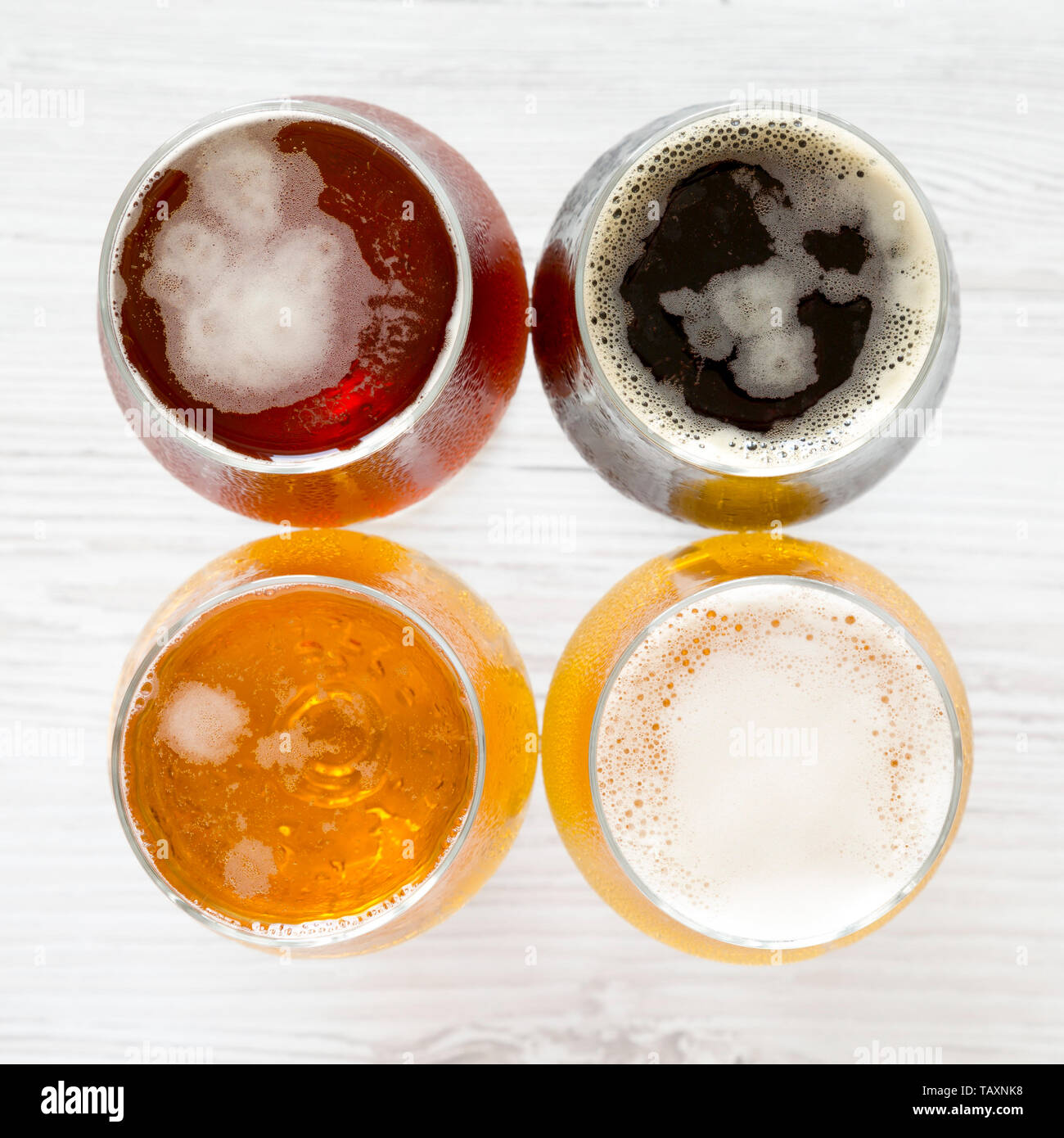 Craft beer assortment on a white wooden background, top view. Overhead ...