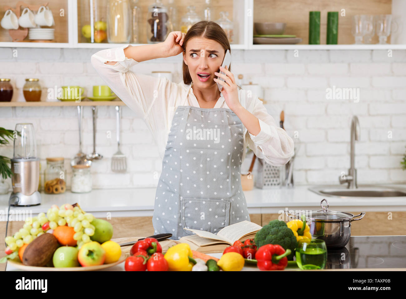 Cooking Dinner. Shocked Woman Talking On Phone Stock Photo - Alamy