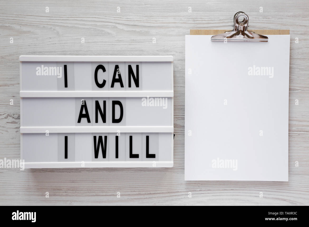 Modern board with 'I can and I will' words, clipboard with blank sheet ...
