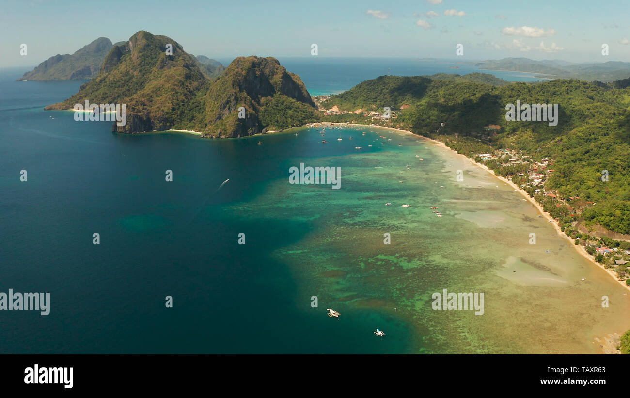 Cove with lagoon and turquoise water on a tropical island against the ...