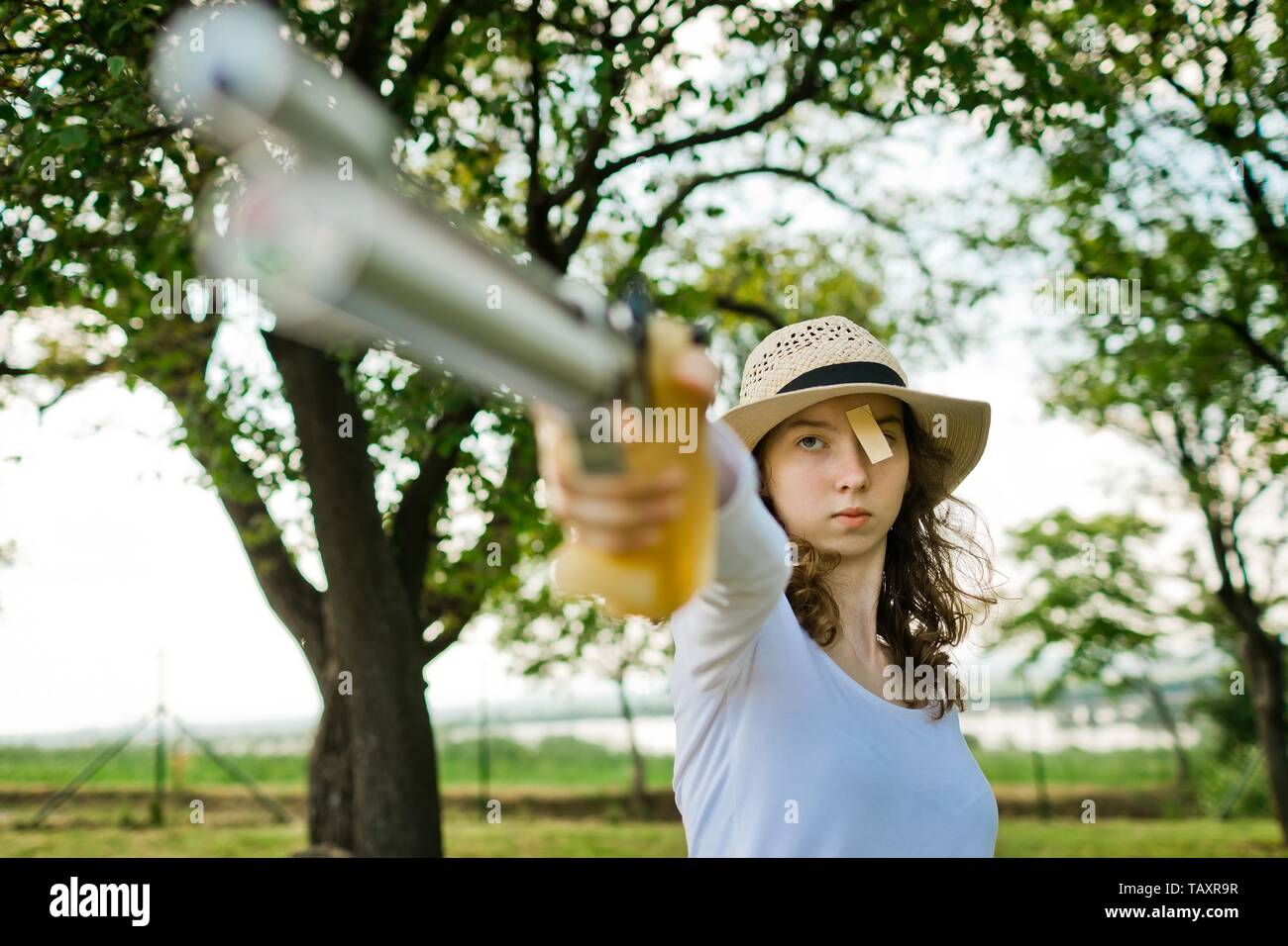 Face of aiming sport female shooter during concentration before shot ...