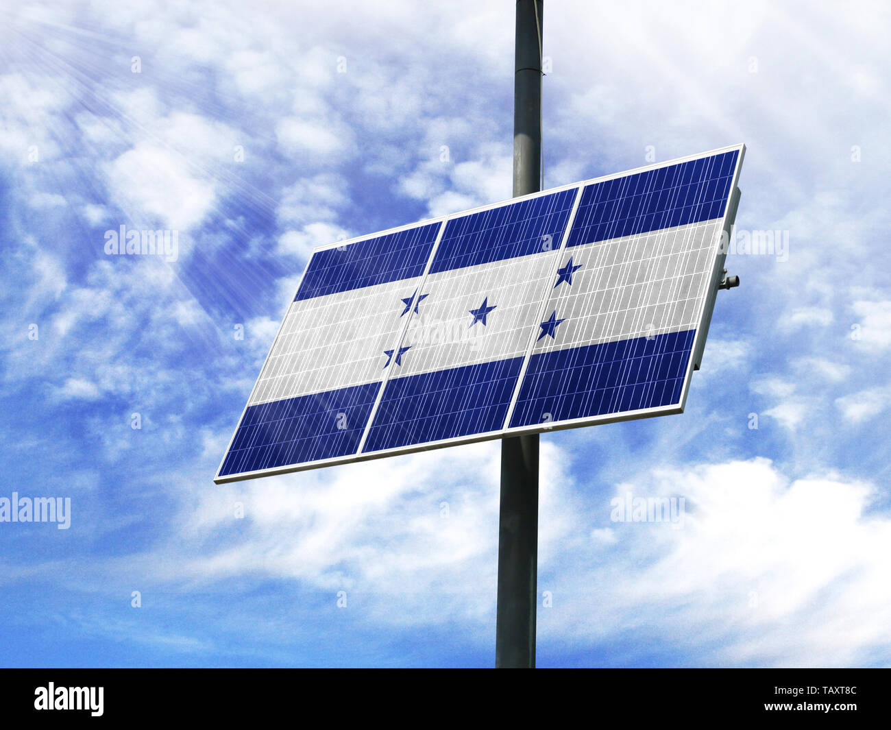 Solar panels against a blue sky with a picture of the flag of Honduras ...