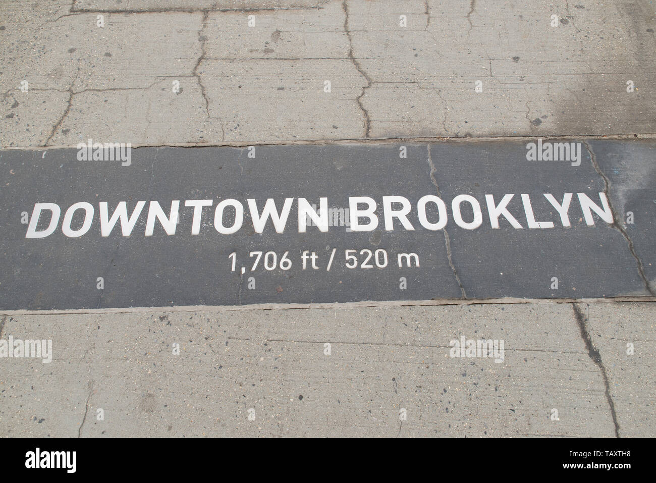 Signs on the ground indicating distances from the end of Brooklyn ...