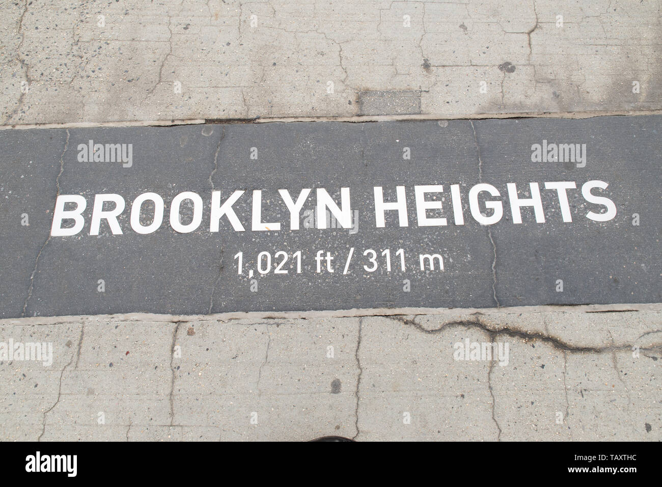 Signs on the ground indicating distances from the end of Brooklyn ...