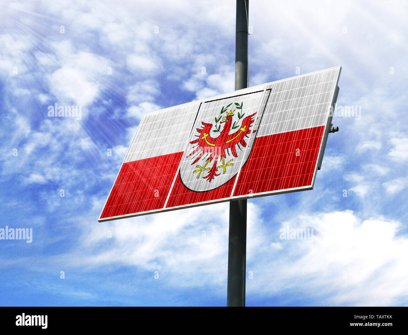 Solar panels against a blue sky with a picture of the flag of Tyrol ...