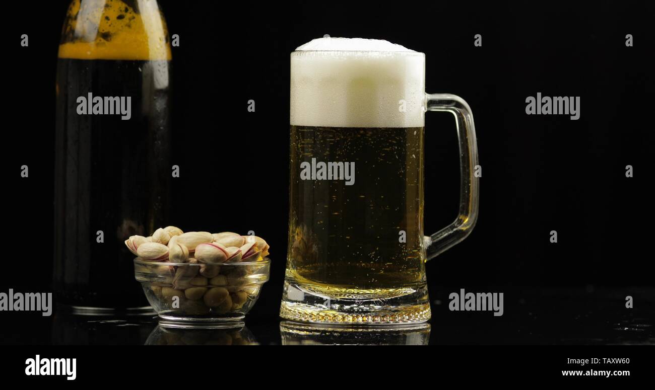 Cold Light Beer in a glass. Craft Beer foam. Bottle of cold beer on a ...
